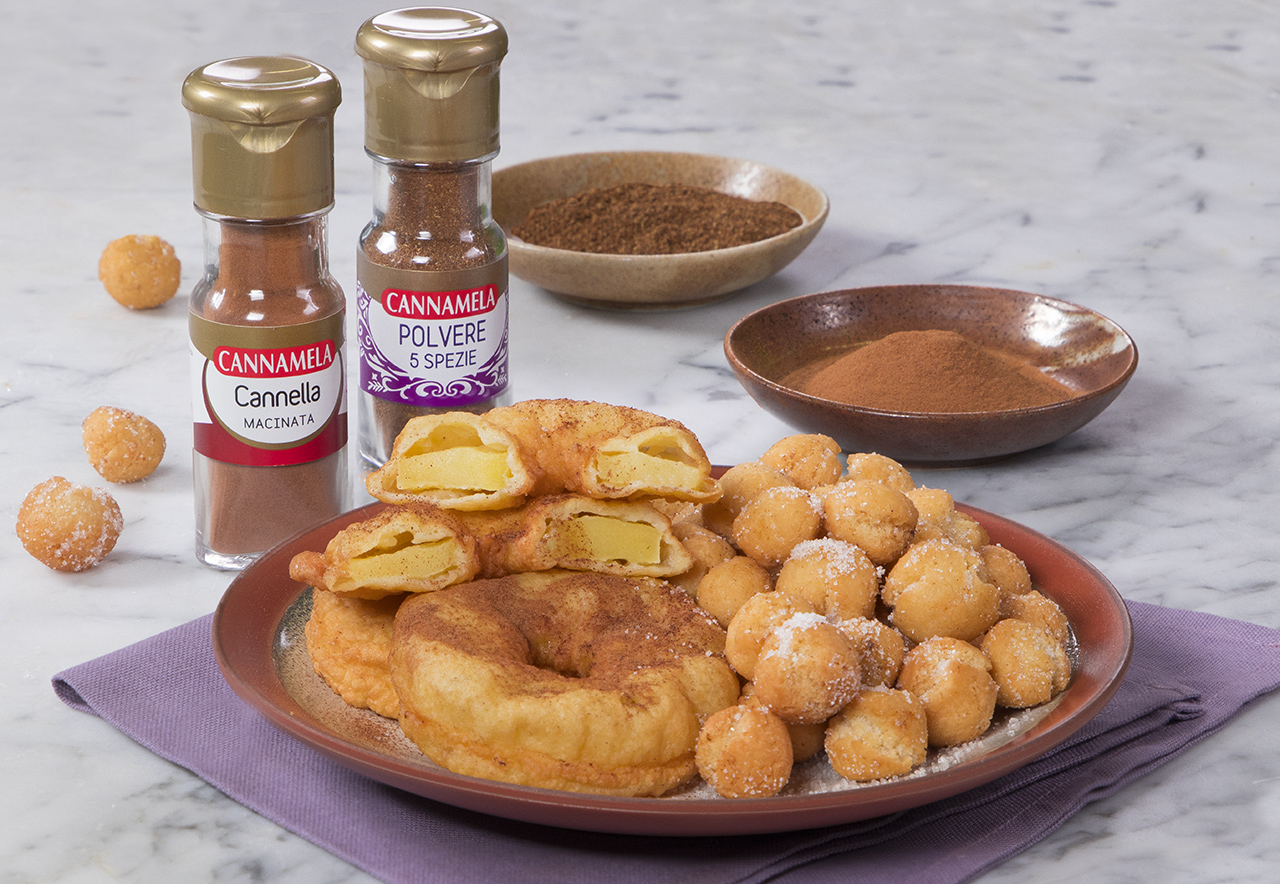 Two types of fritters: apple and cinnamon and castagnole with 5 spices ...